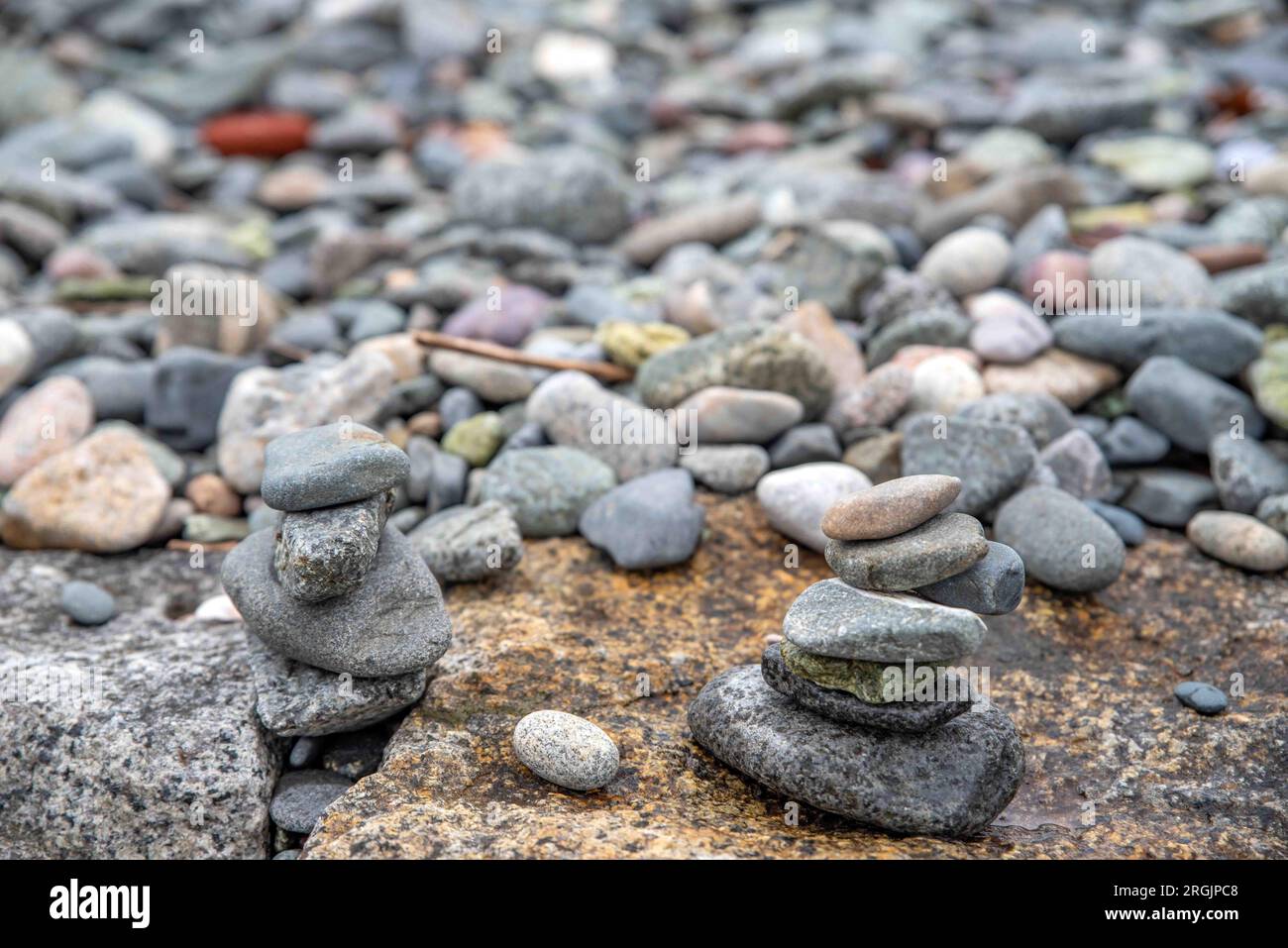 Closeup high angle view of smooth gray and colored stones on a New ...