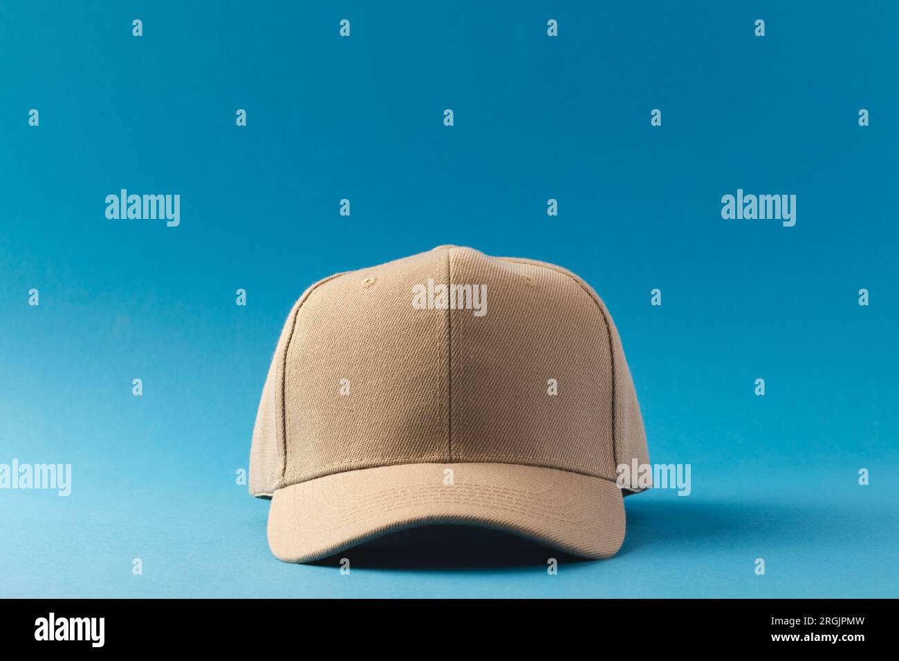 Cream baseball cap and copy space on blue background Stock Photo - Alamy