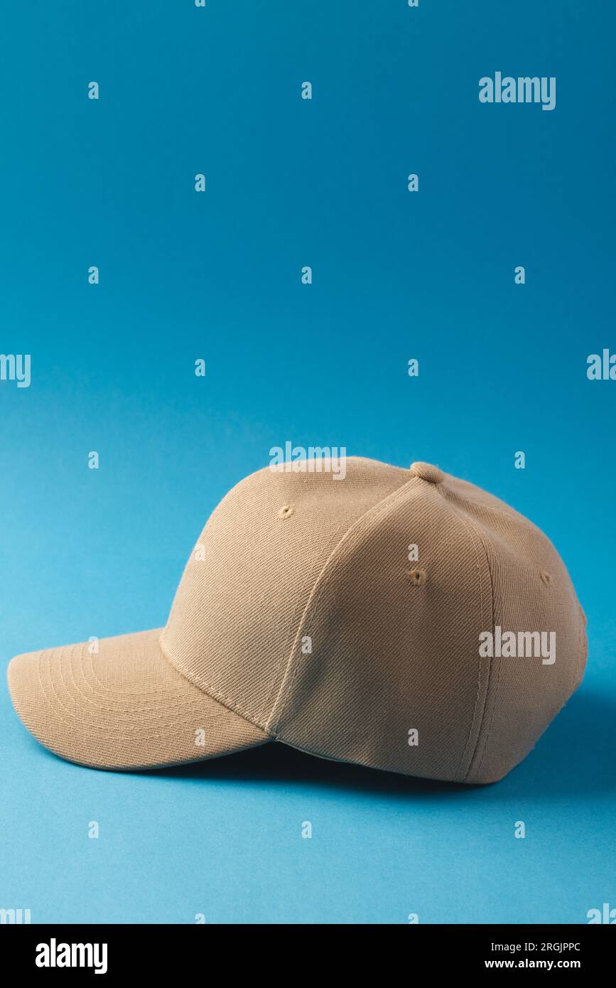 Cream baseball cap and copy space on blue background Stock Photo - Alamy