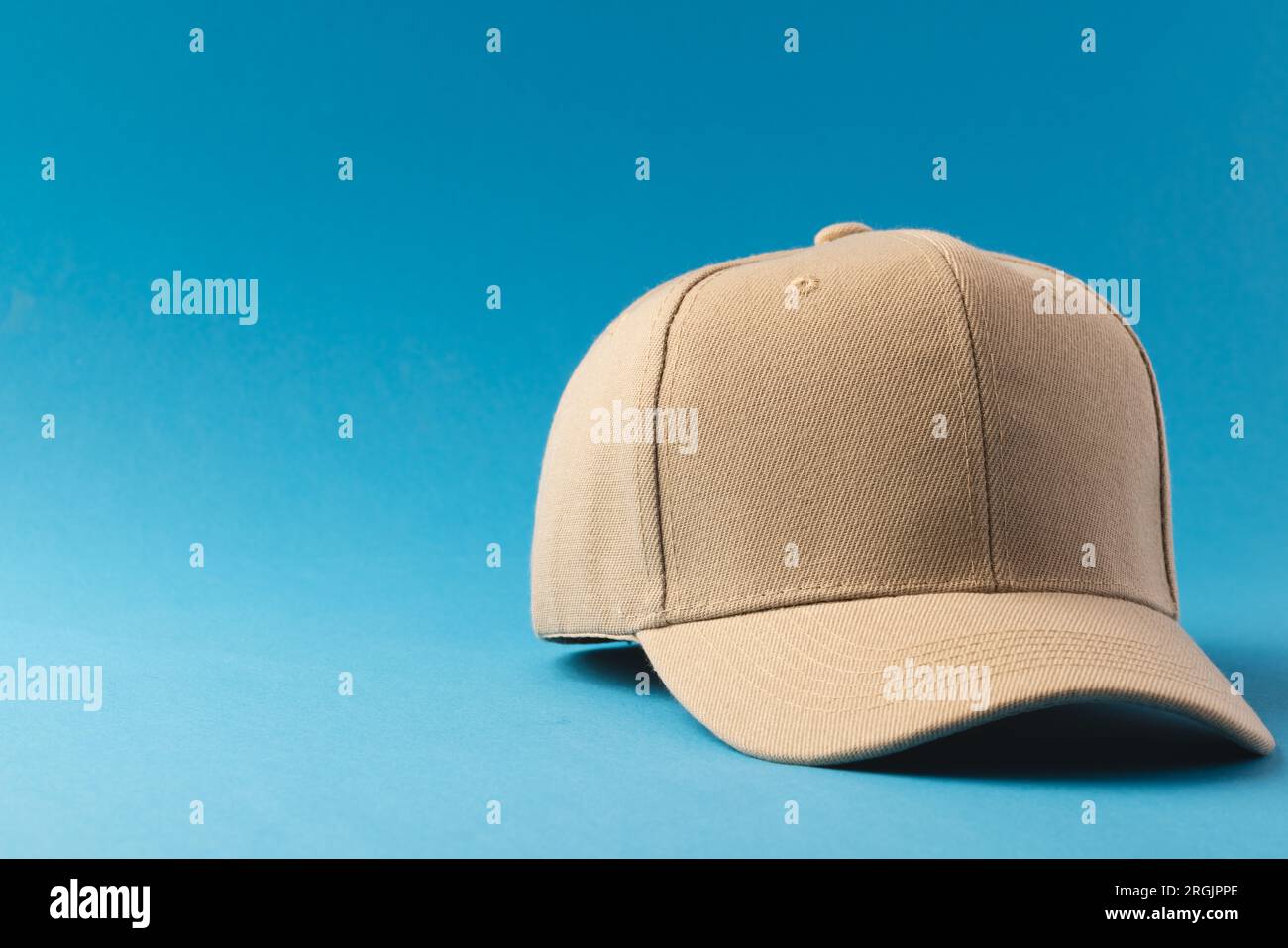 Cream baseball cap and copy space on blue background Stock Photo - Alamy