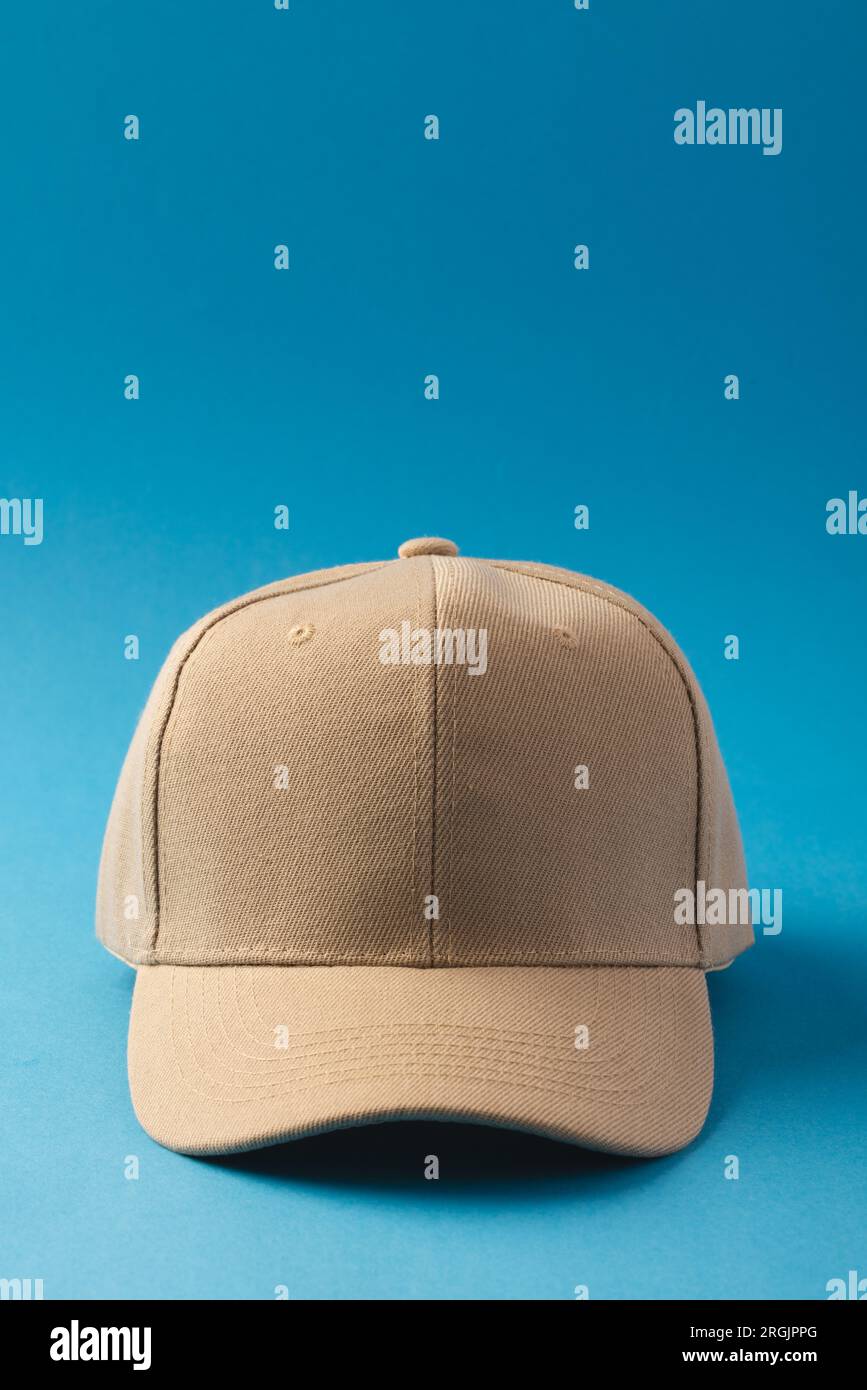 Cream baseball cap and copy space on blue background Stock Photo - Alamy