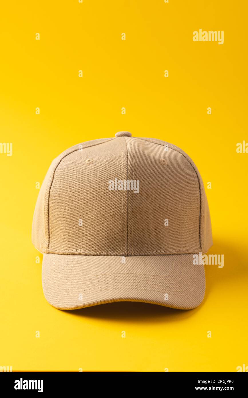Cream baseball cap and copy space on yellow background Stock Photo - Alamy