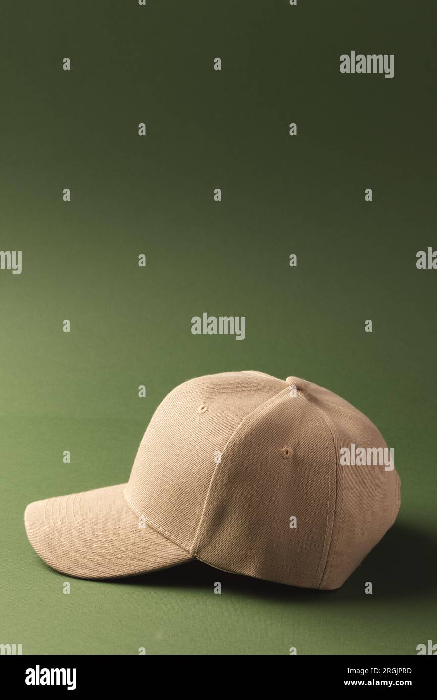 Cream baseball cap and copy space on green background Stock Photo - Alamy
