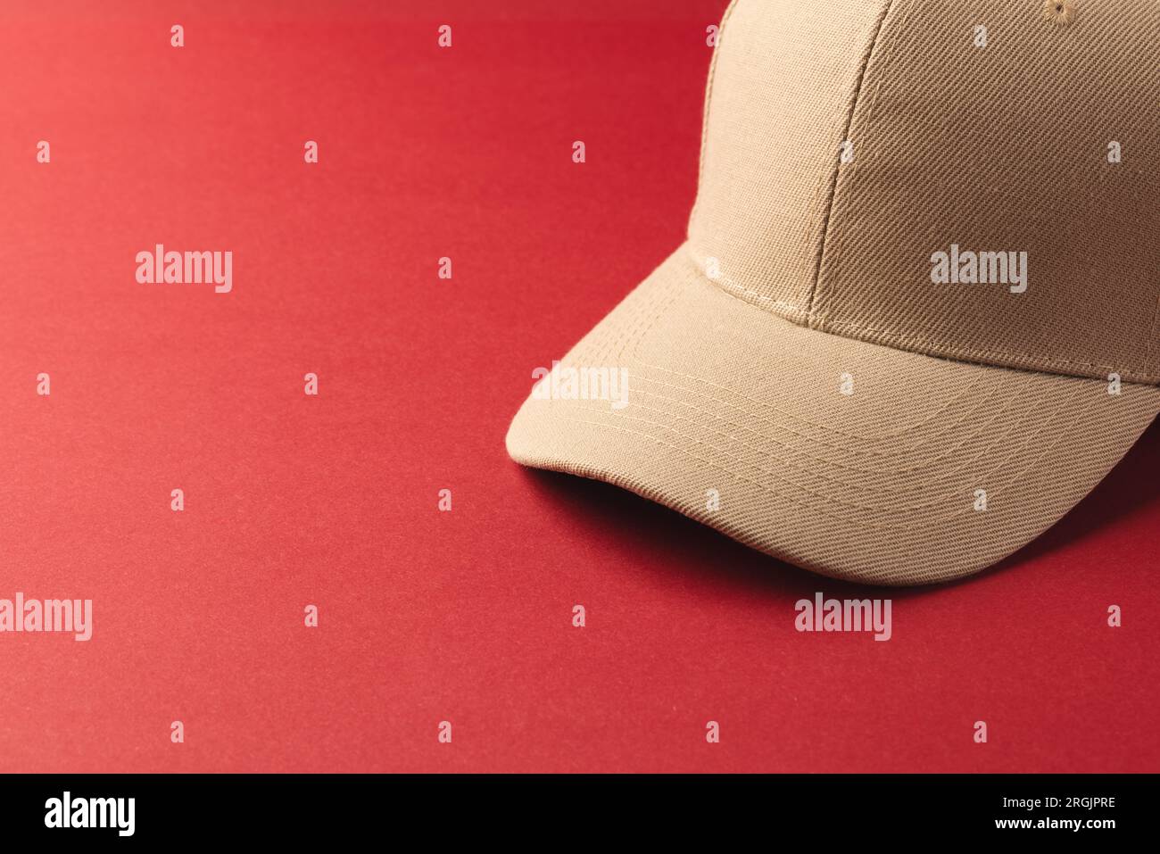 Cream baseball cap and copy space on red background Stock Photo - Alamy