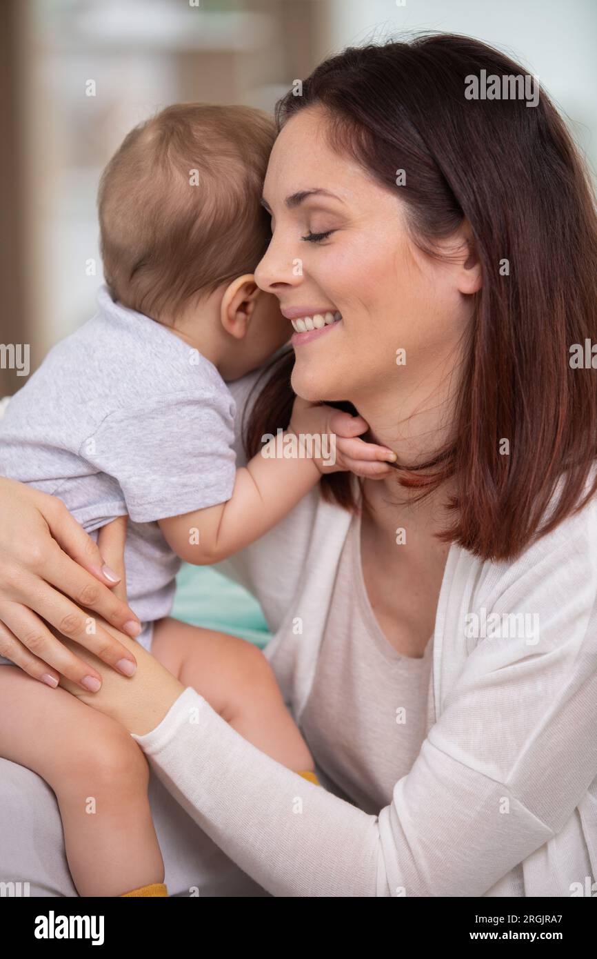 pretty woman holding a newborn baby in her arms Stock Photo - Alamy