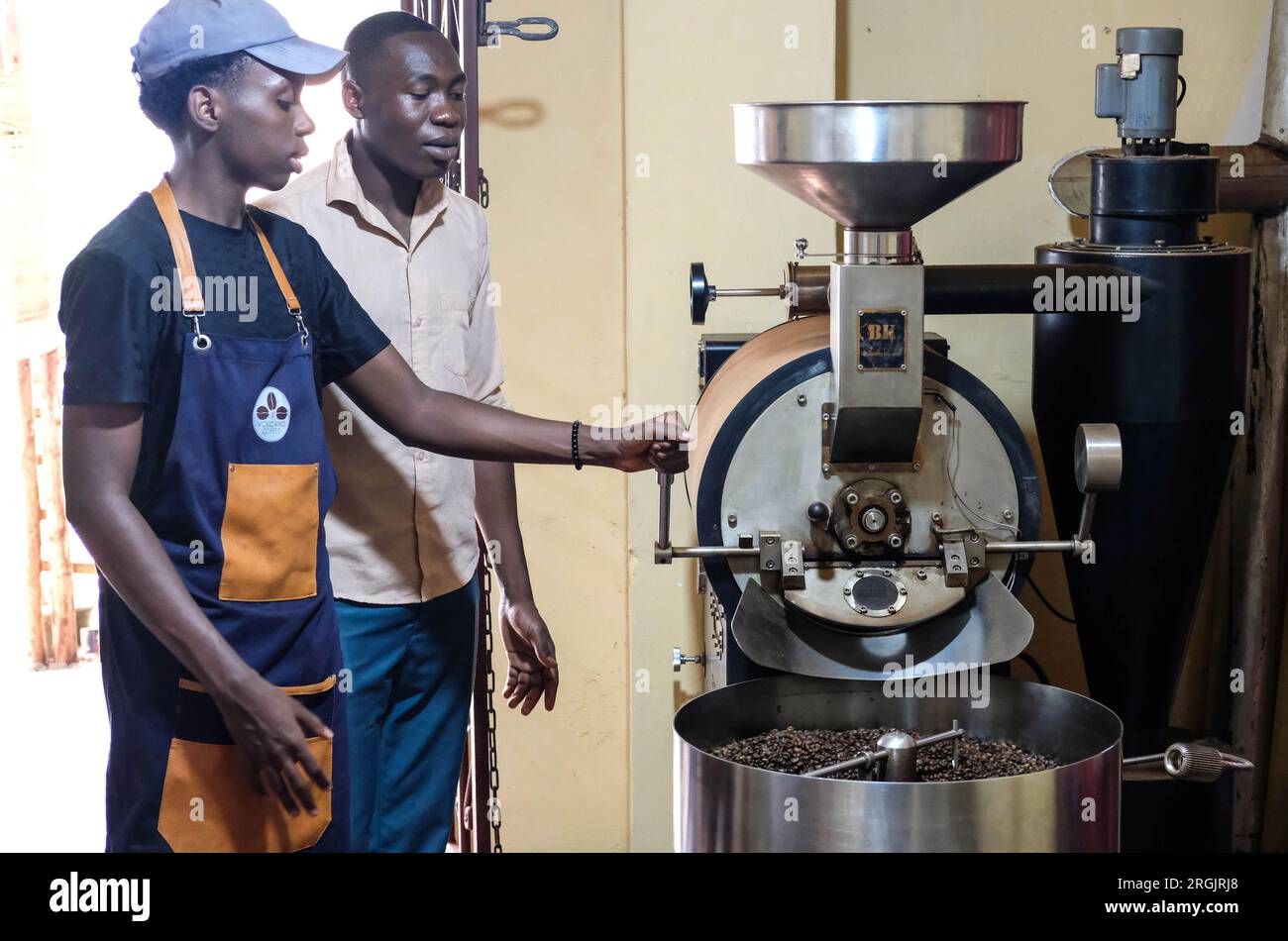 Kampala. 7th Aug, 2023. Workers roast coffee beans with a machine at ...