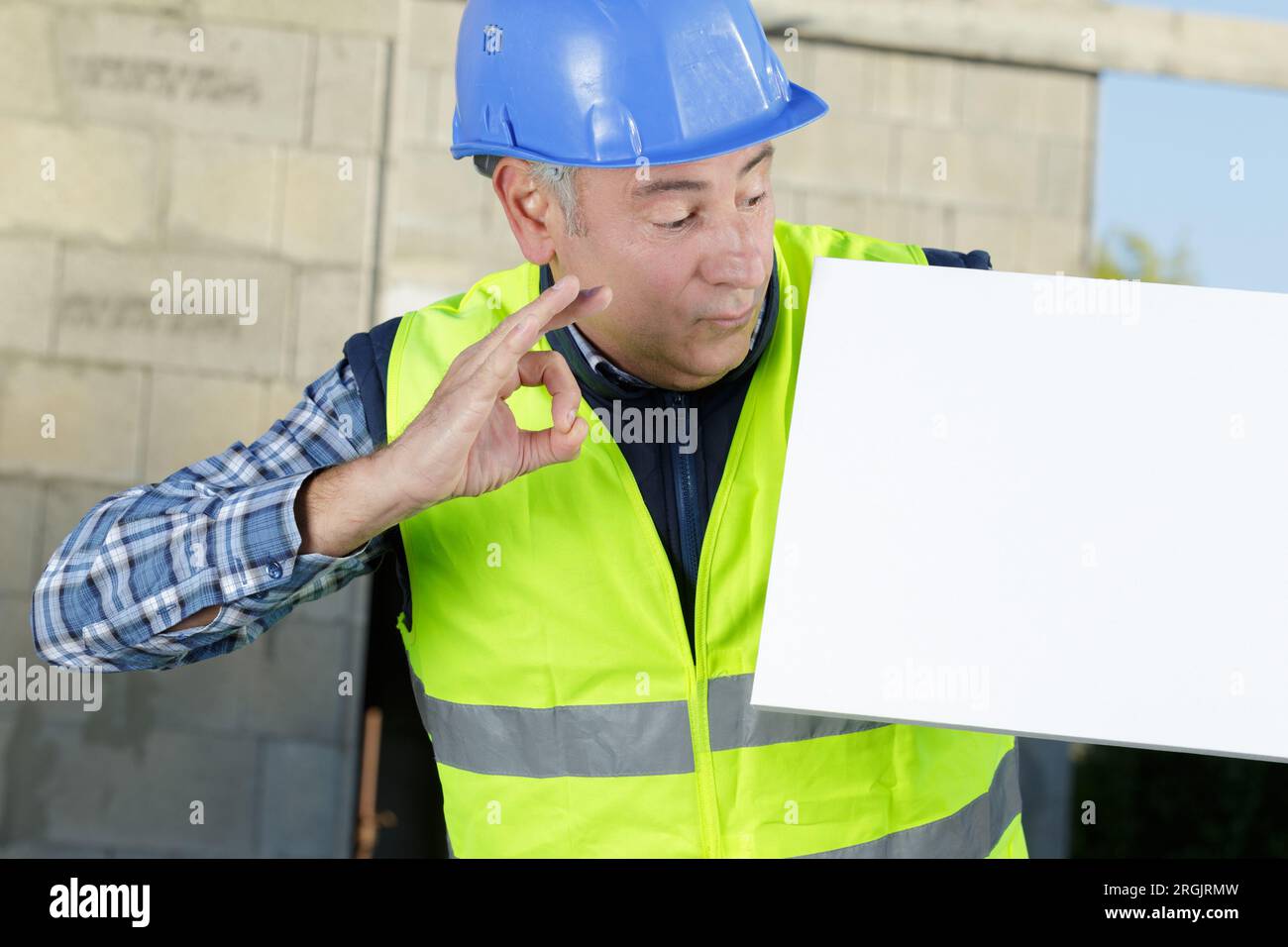builder holding blank sign and making gesture of approval Stock Photo ...