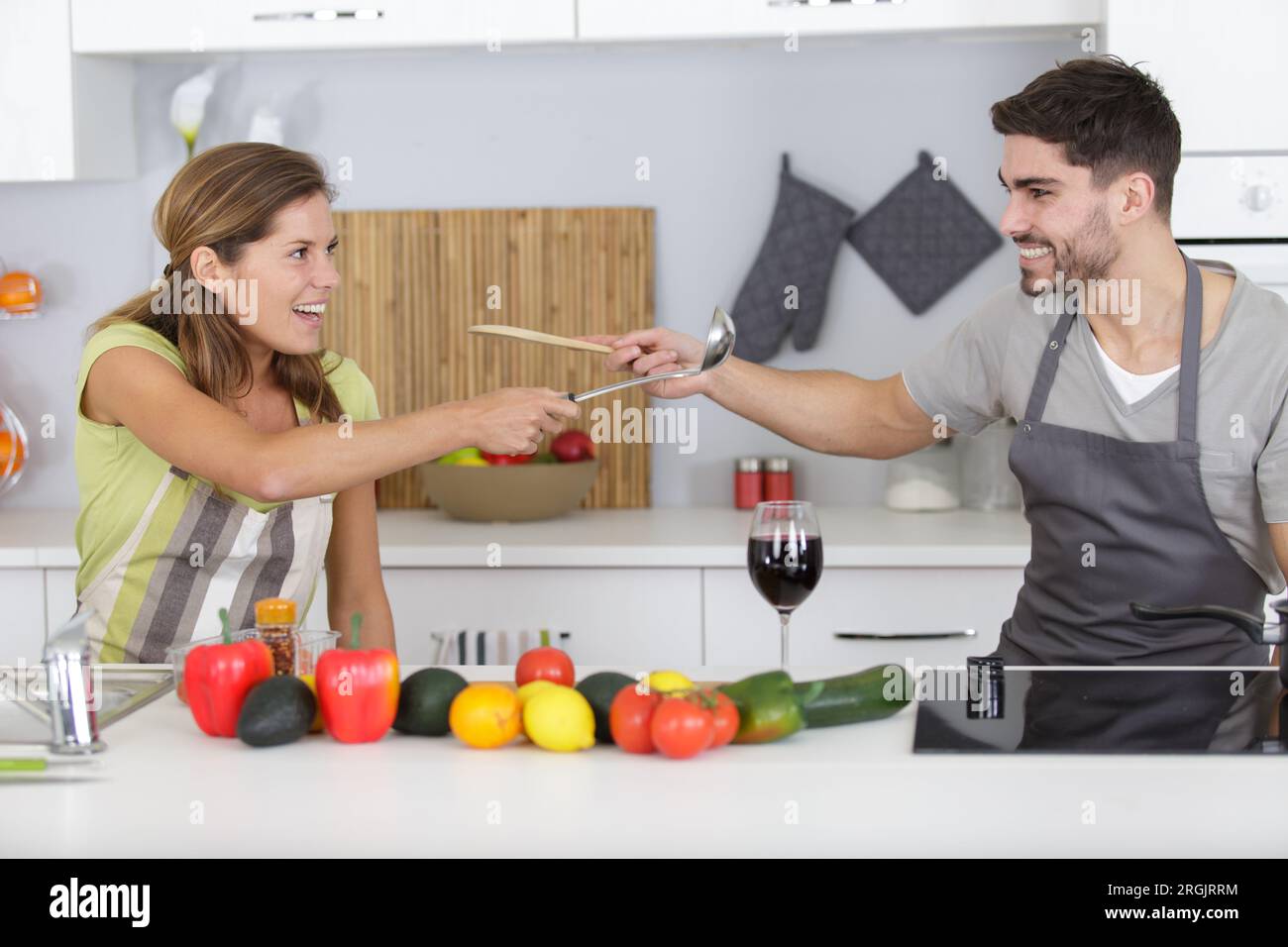 couple having fun fight in kitchen Stock Photo - Alamy