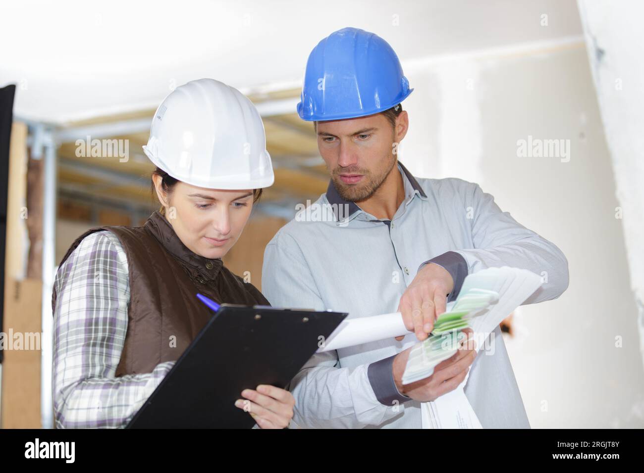 architect and builder with clipboard in construction site Stock Photo ...
