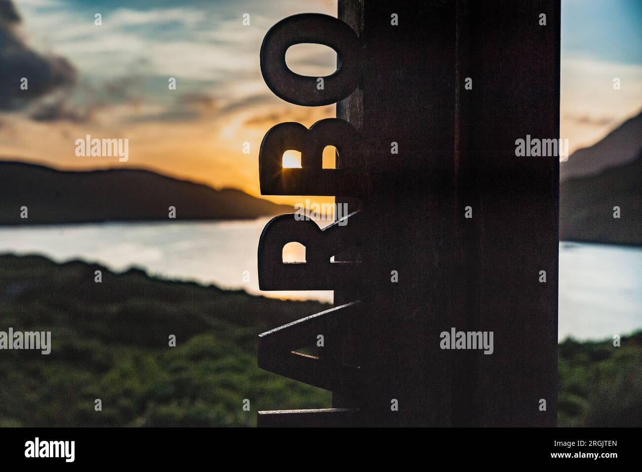 Detail of Killary Harbour sign at sun set with the ocean in background ...