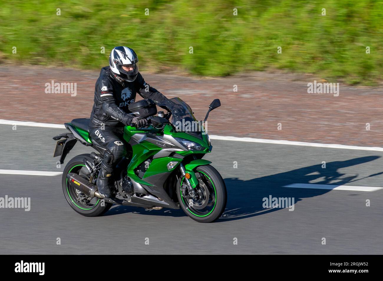Green Kawasaki Z1000 SX travelling at speed on the M6 motorway in ...