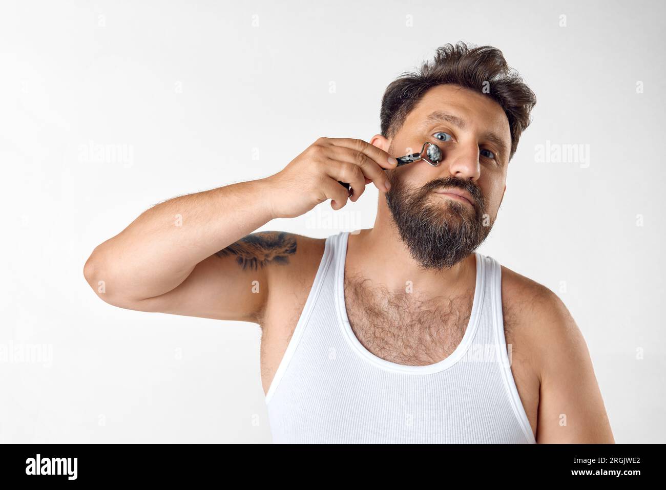 Morning refreshment. Bearded man taking care after skin, doing face ...