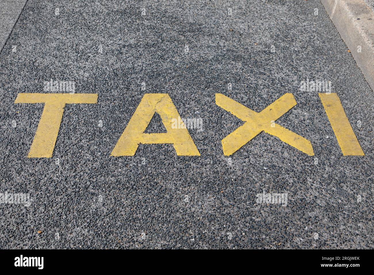 taxi sign painted on taxis car parking spot floor street road signage ...