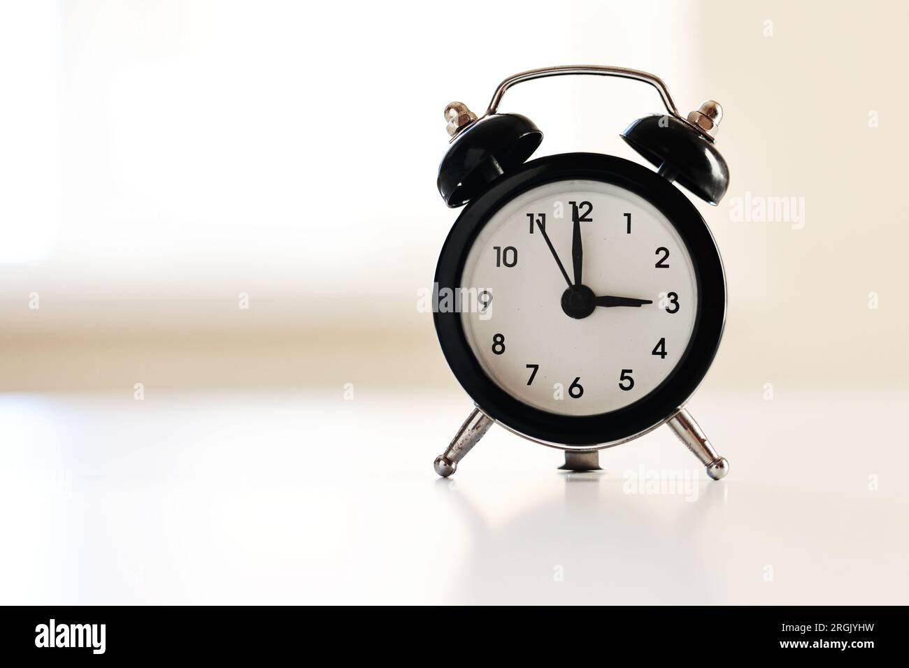 Modern black and white alarm clock in retro style isolated on white and ...