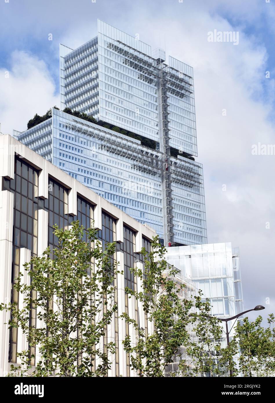 Clouds & blue sky reflected in the glazing of the hi-tech, energy ...