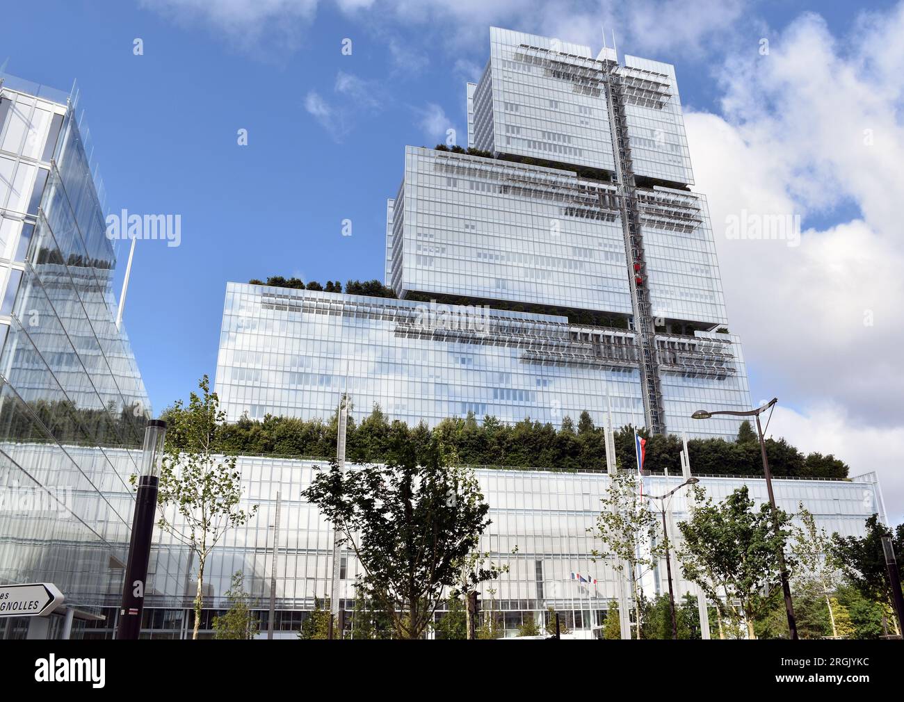 Clouds & blue sky reflected in the glazing of the hi-tech, energy ...