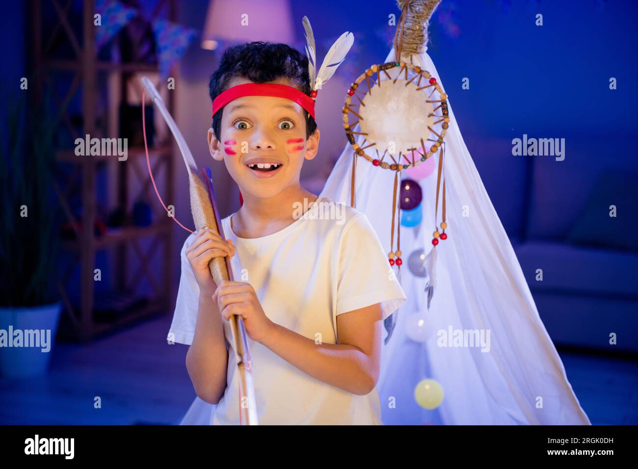 Photo of happy amazed boy in traditional costume playing favorite ...