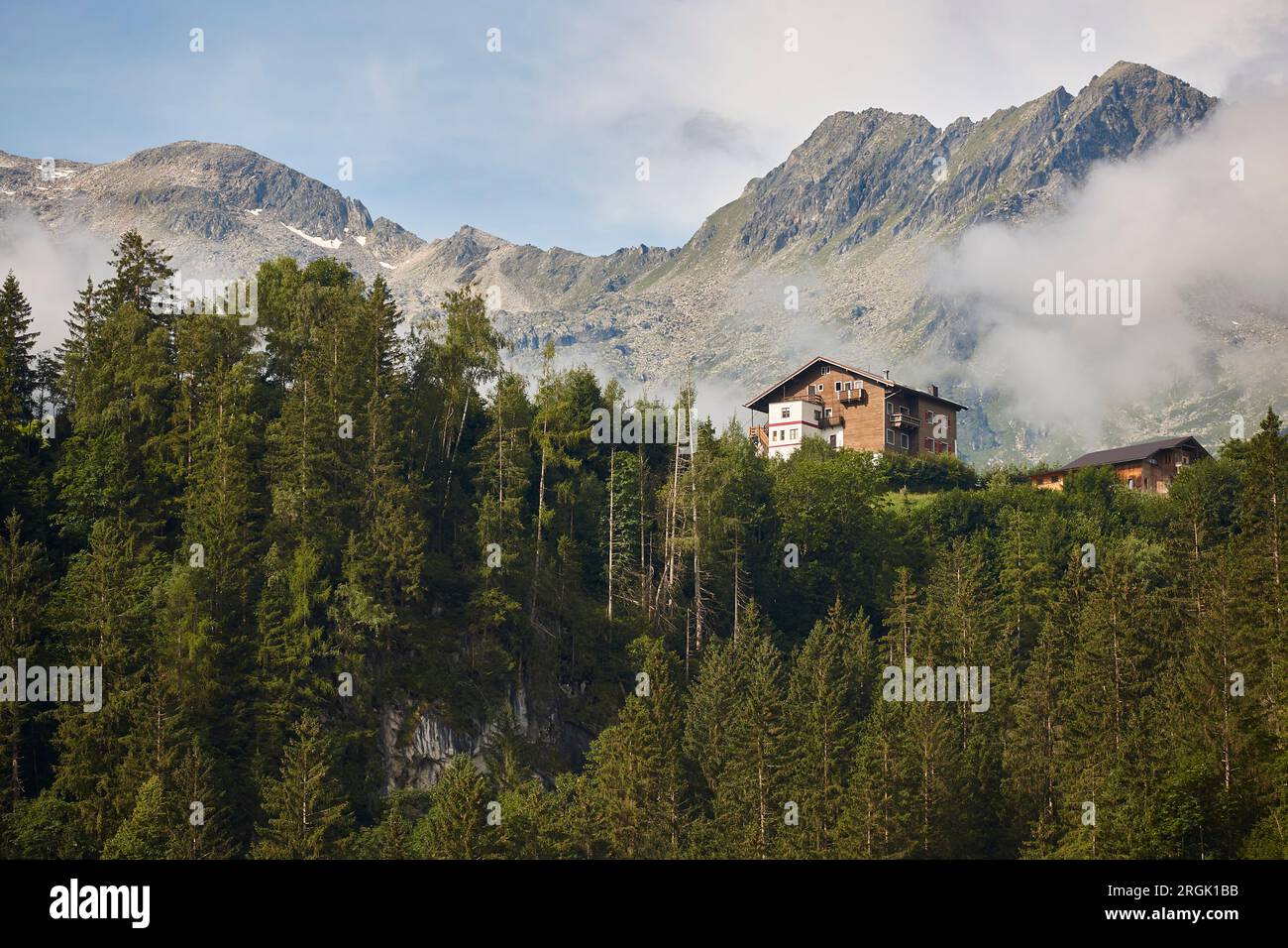 Forest and mountain landscape in Tyrol region. Traditional house ...