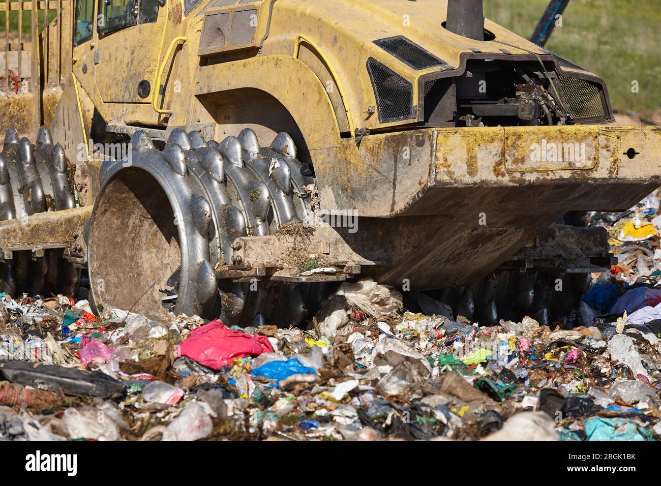 Heavy machinery shredding garbage in an open air landfill. Waste Stock ...