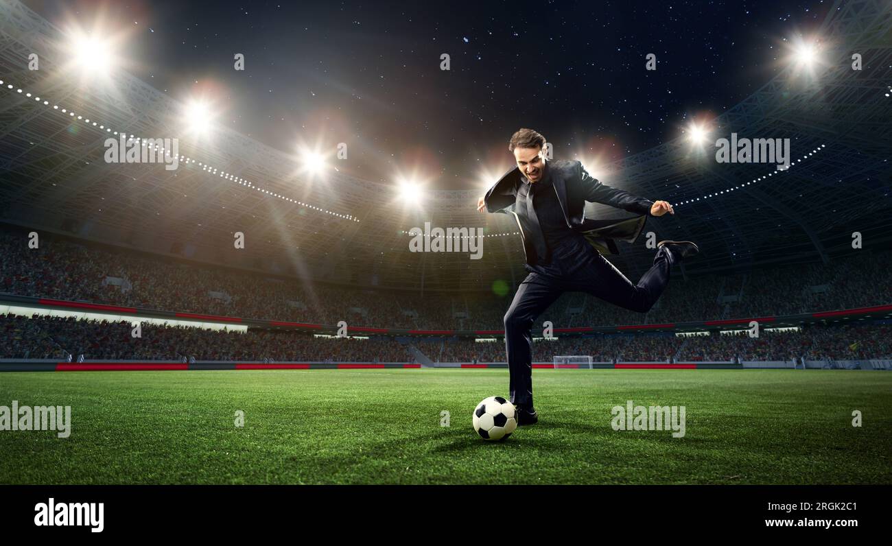 Emotional businessman hitting football ball on 3d arena with ...