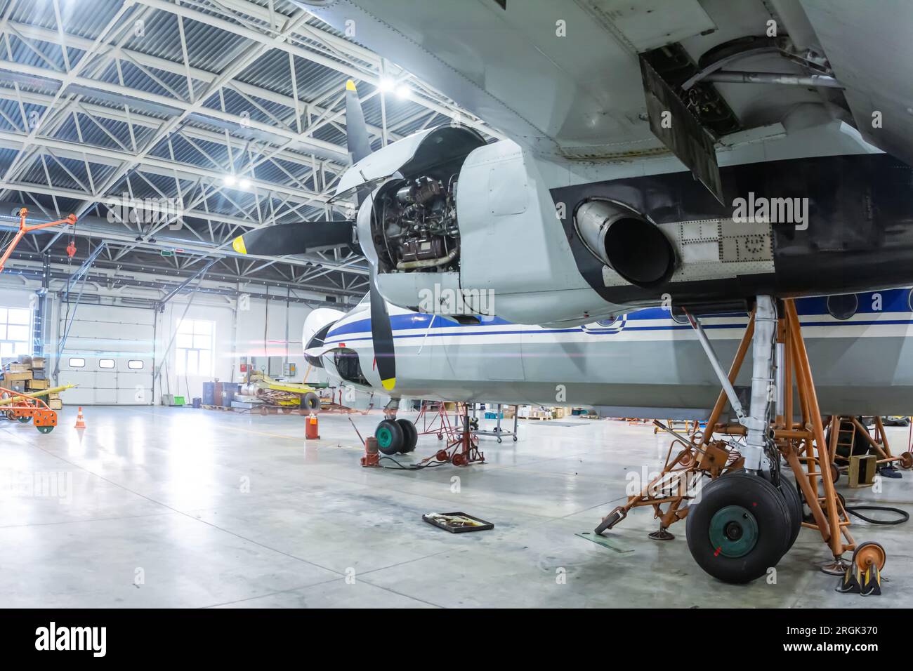 Transport turboprop airplane in the hangar. Aircraft under maintenance ...