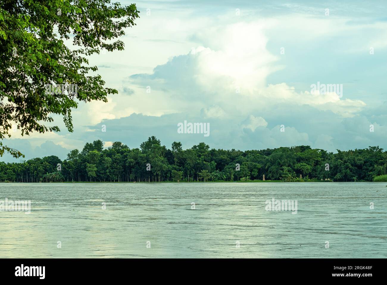 Marvelous spring landscape at the village by the lake with green fields ...