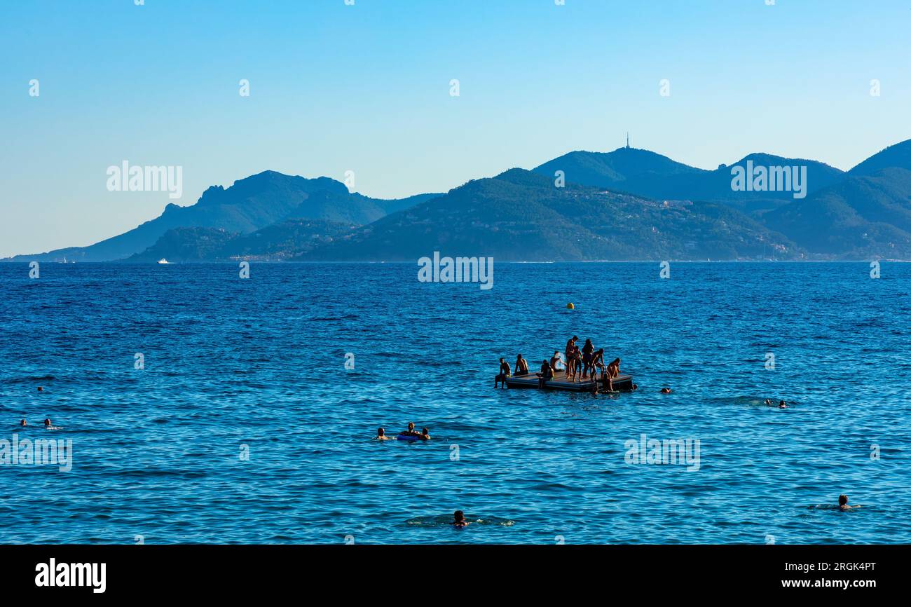 Cannes, France - July 31, 2022: Tourists enjoying sun and water on boat ...