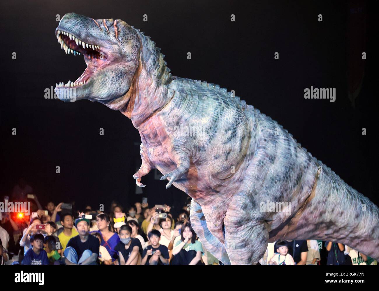 Yokohama, Japan. 10th Aug, 2023. An actor wearing dinosaur shaped ...