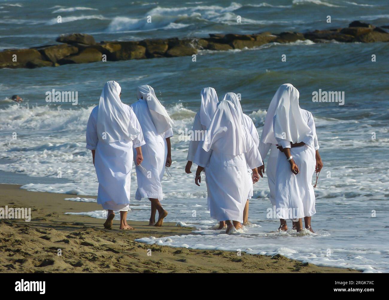 Nuns walk in the sand on the beach 02 Stock Photo - Alamy