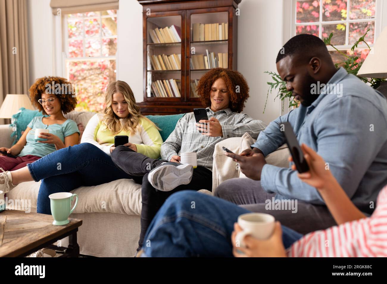 Diverse group friends using hi-res stock photography and images - Alamy