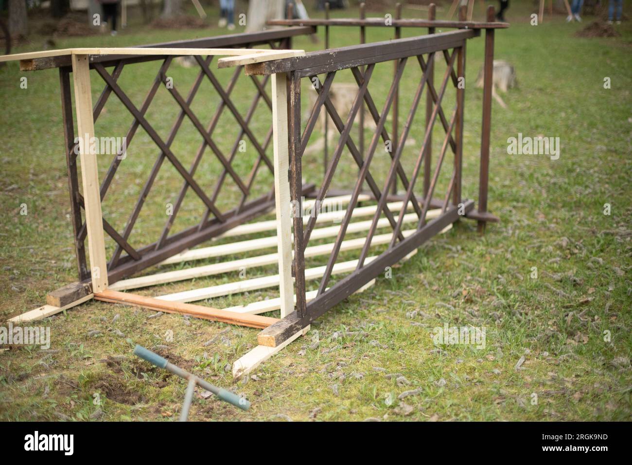 Wooden construction. Structure lies on grass. Wooden beams. Creation of ...