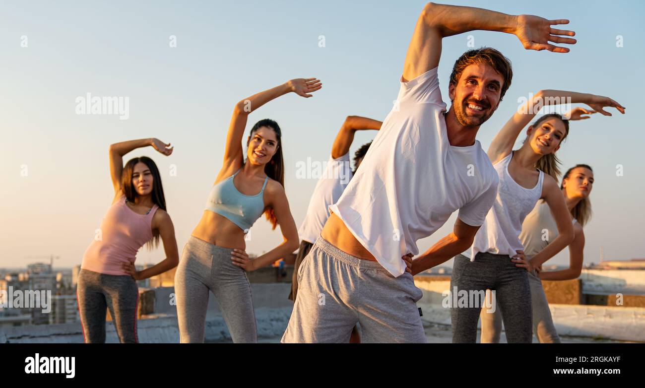 Group of fit healthy friends, people exercising together outdoor Stock ...