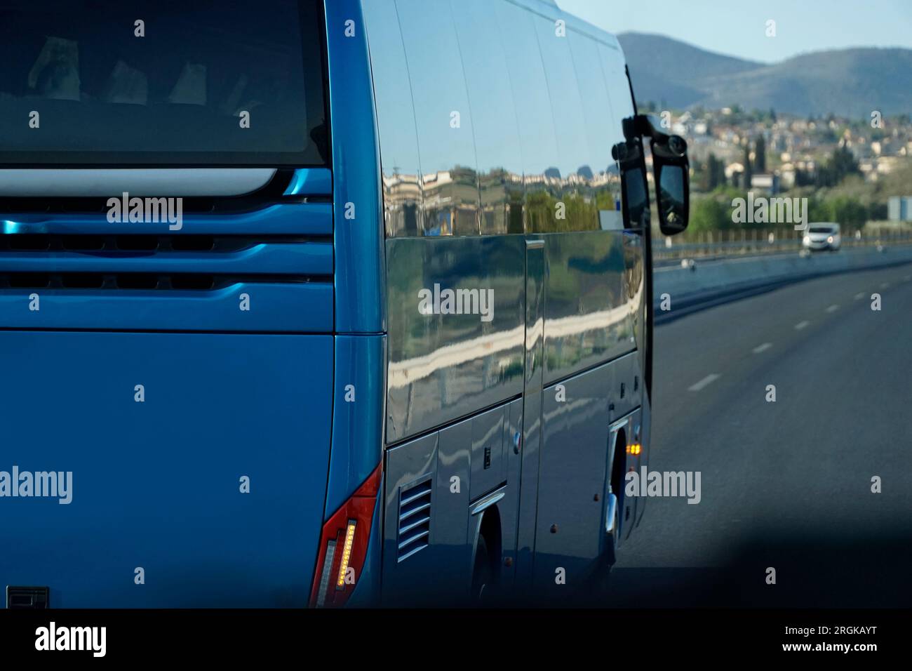 Tourist bus on a highway - back view Stock Photo - Alamy