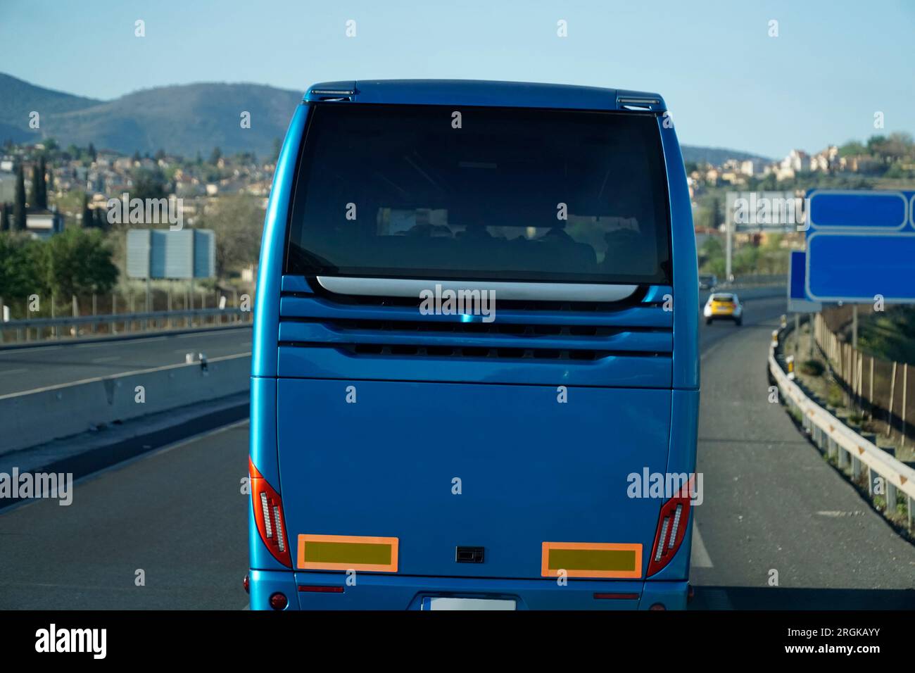 Tourist bus on a highway - back view Stock Photo - Alamy