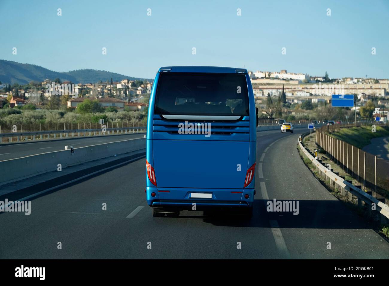 Tourist bus on a highway - back view Stock Photo - Alamy