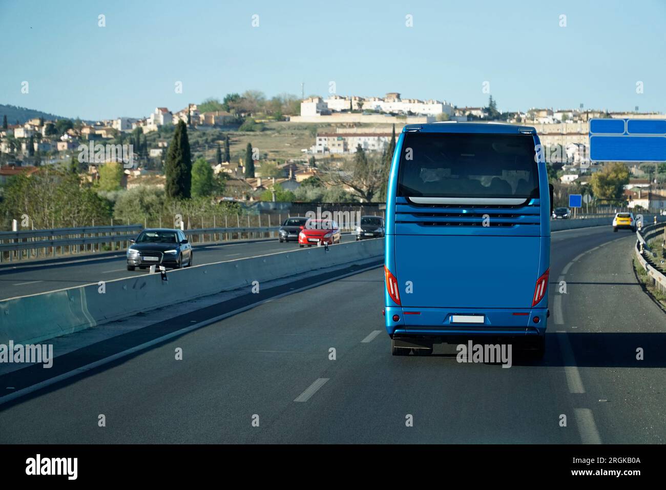 Tourist bus on a highway - back view Stock Photo - Alamy