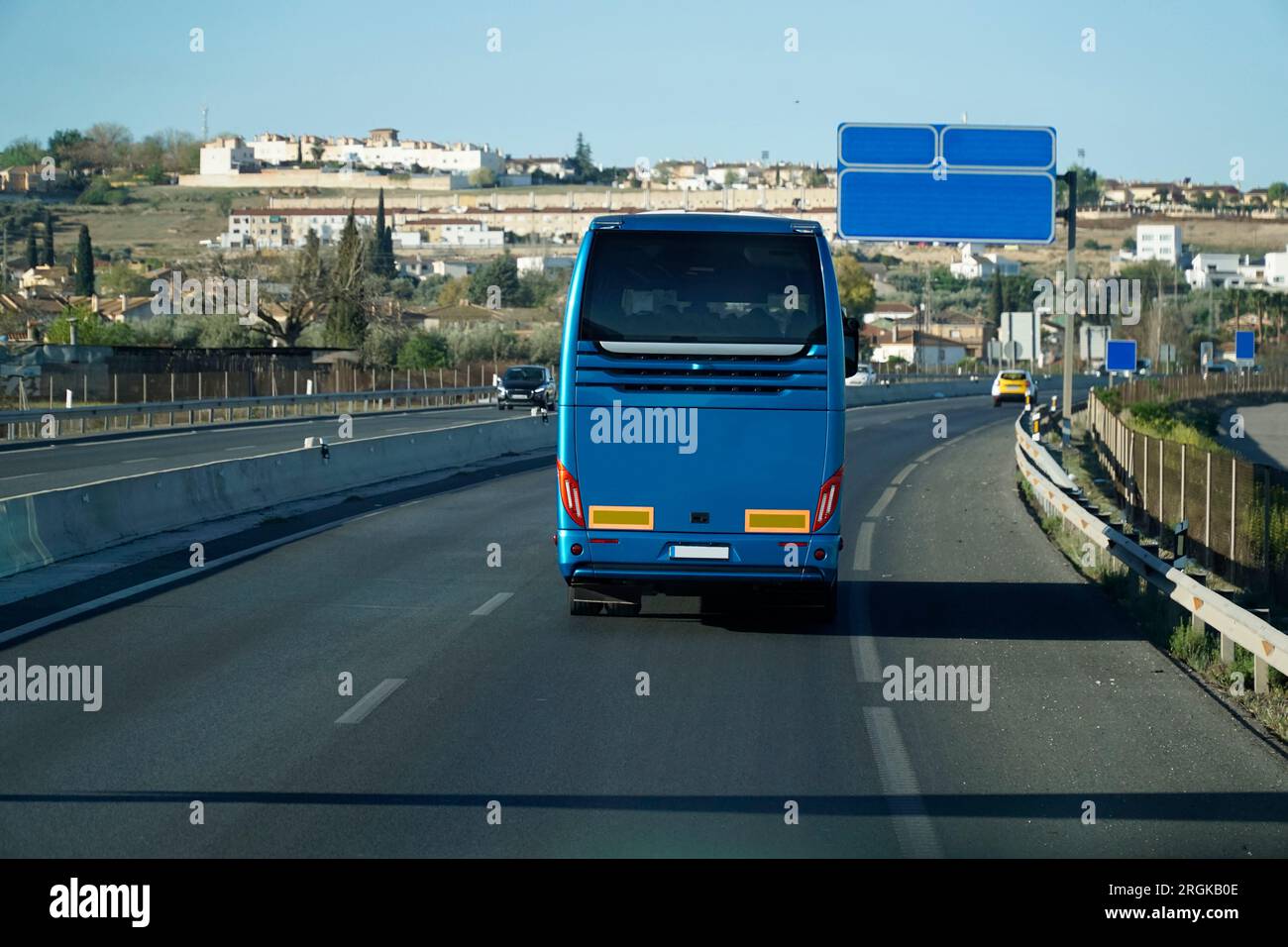 Tourist bus on a highway - back view Stock Photo - Alamy
