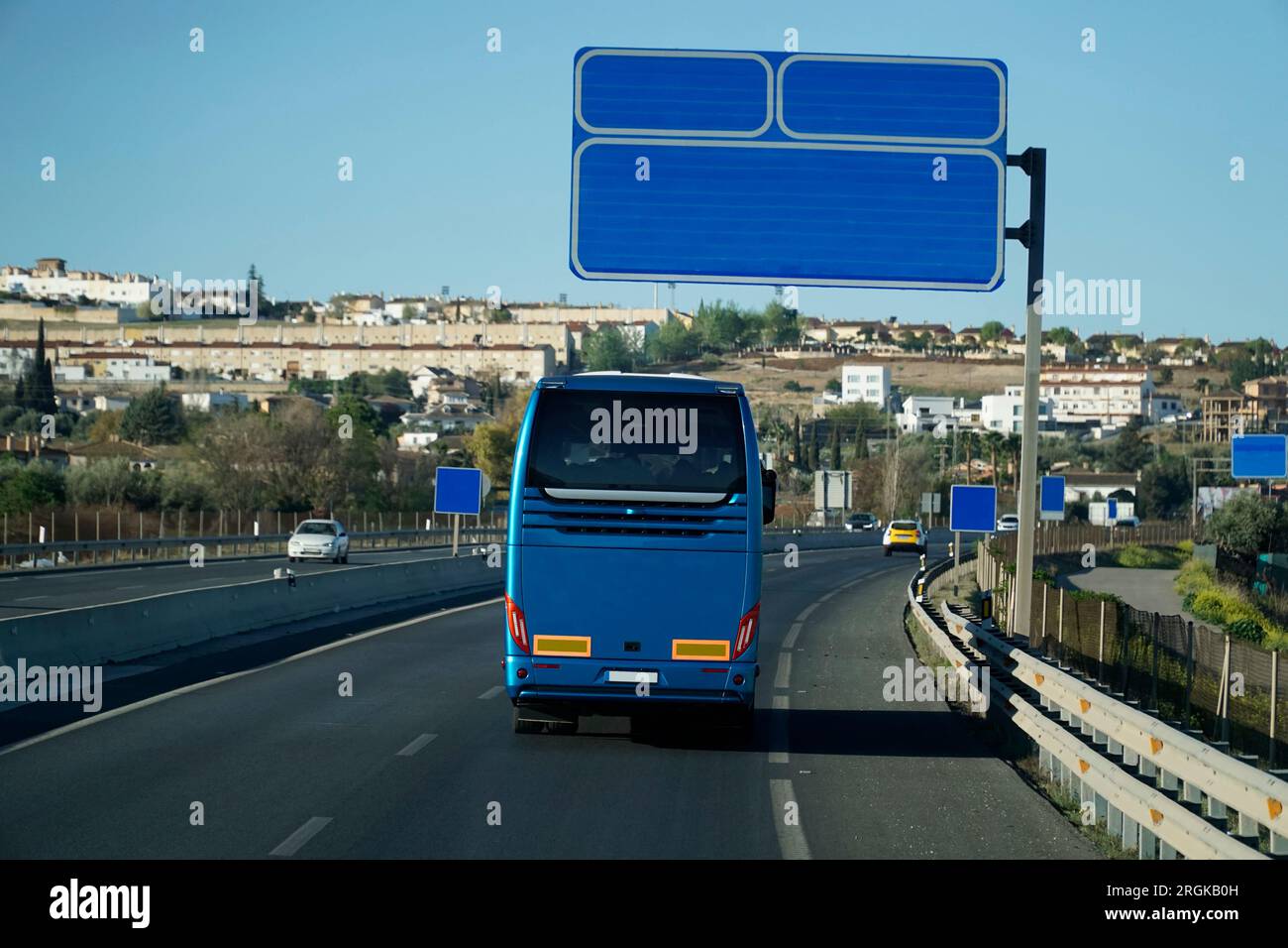 Tourist bus on a highway - back view Stock Photo - Alamy
