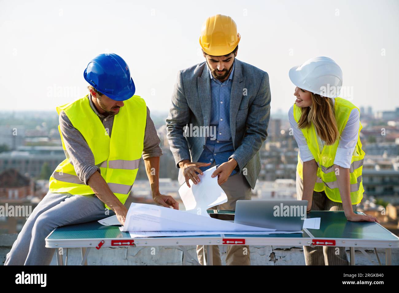 Group of engineers, architects, business partners at construction site ...