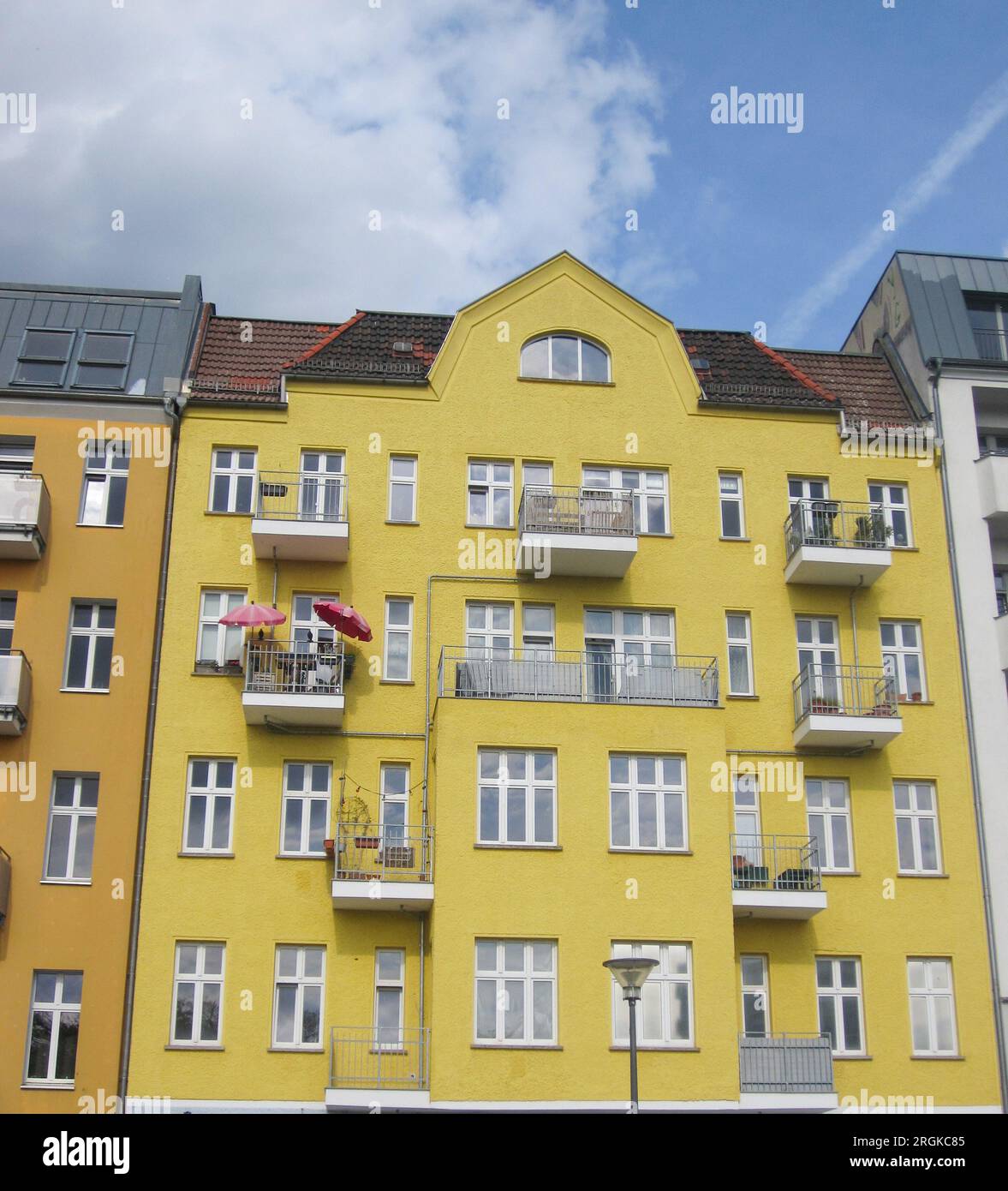 Colourful yellow apartment buildings in Berlin Germany cute balcony ...