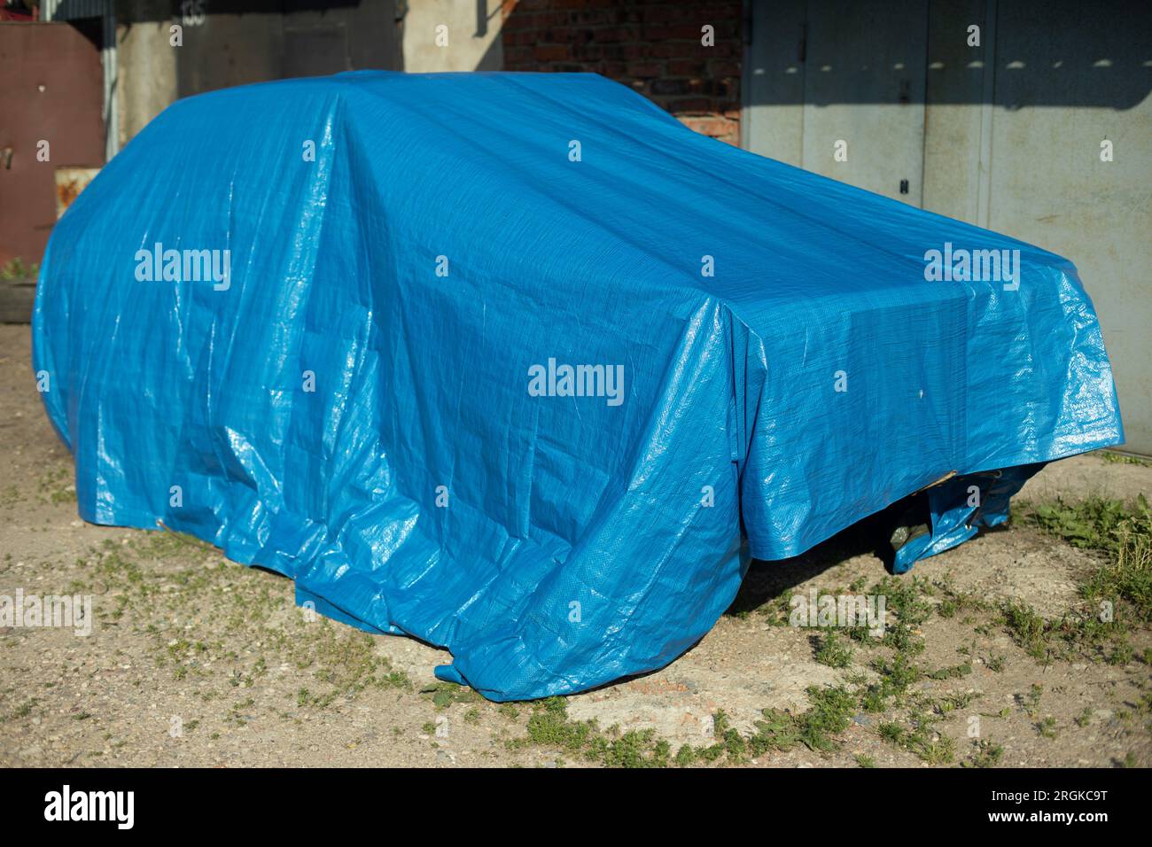 Car is covered with awning. Blue awning on car. Protected vehicles ...
