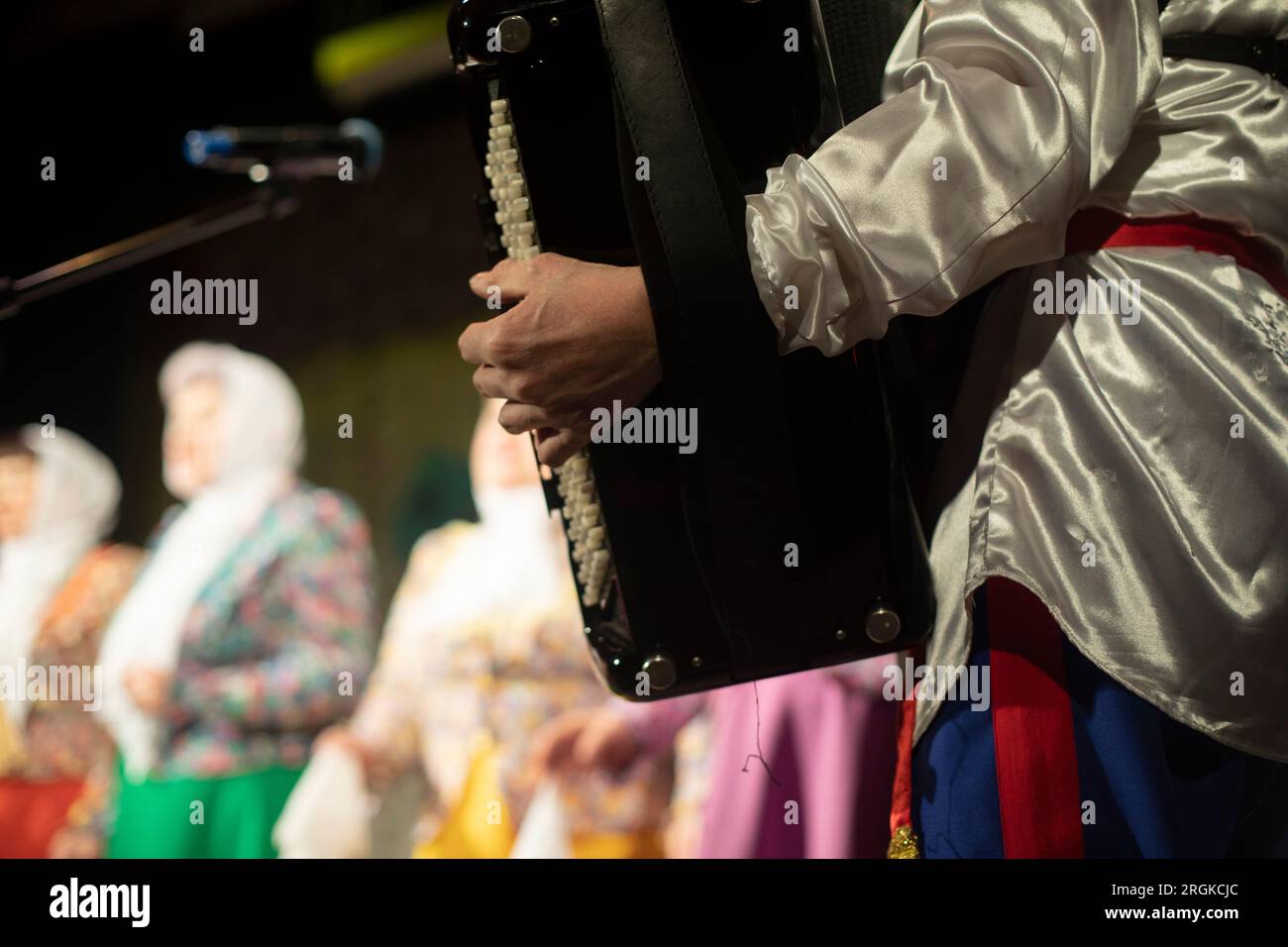 Playing folk instrument. Folklore ensemble. Accardion in hand ...