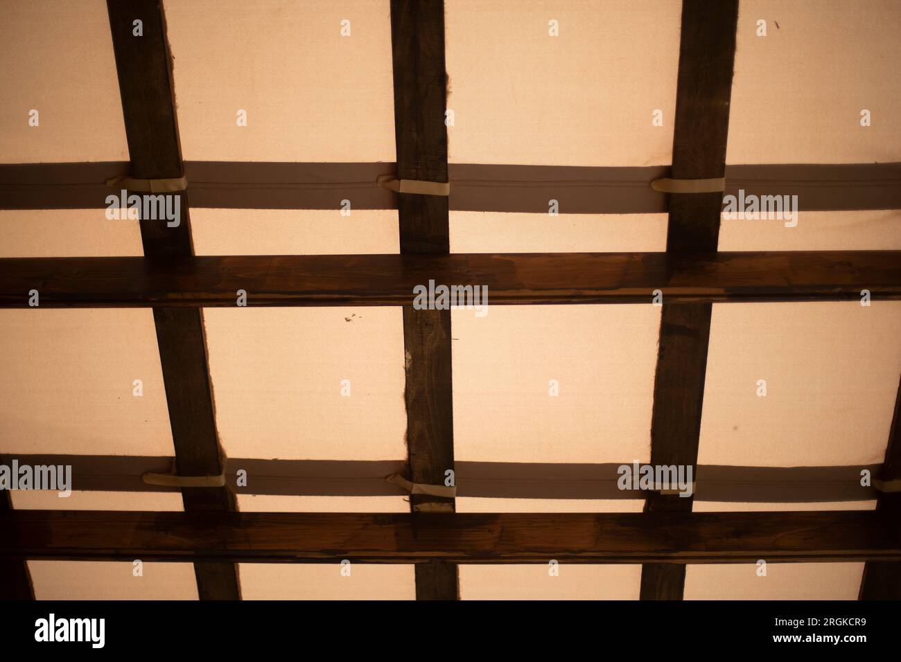 Roof inside. Roof made of planks. Interior details. Ceiling in lattice ...
