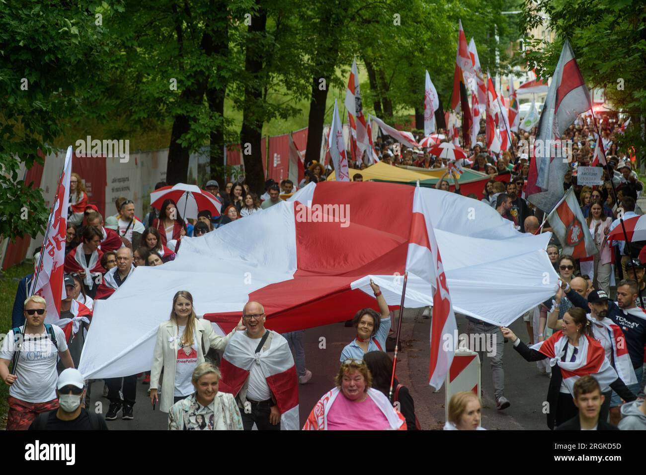 Demonstrators carry a huge white-red-white flag during the Belarusians ...