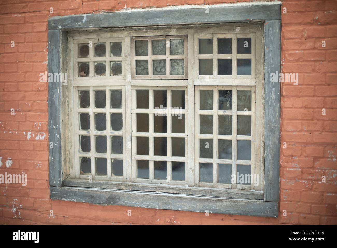 Window with grille in wall. Old window. Wall of house. Wooden lattice ...