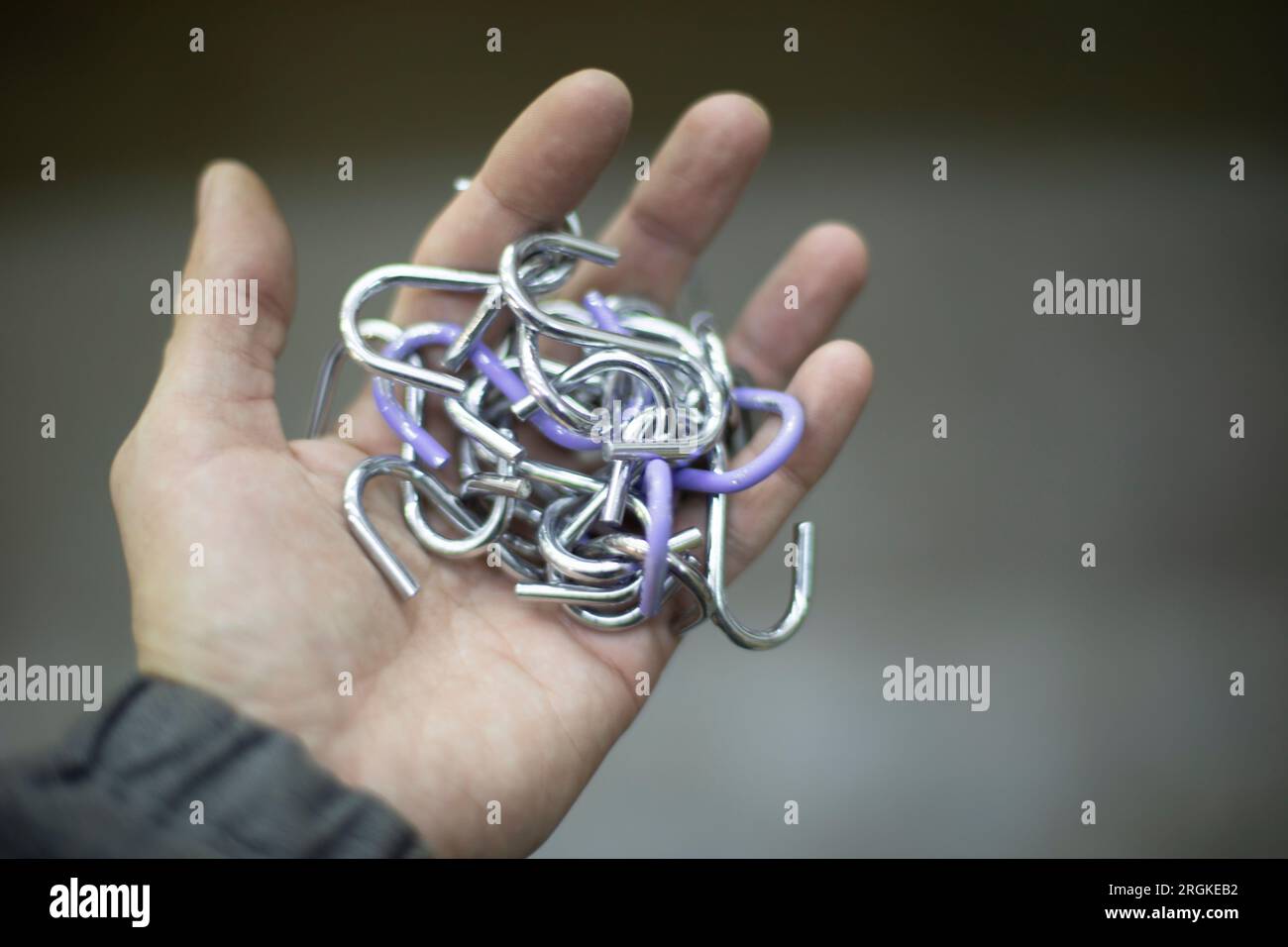 Chain in hand. Steel links. Lock in palm of your hand. Chain links in ...