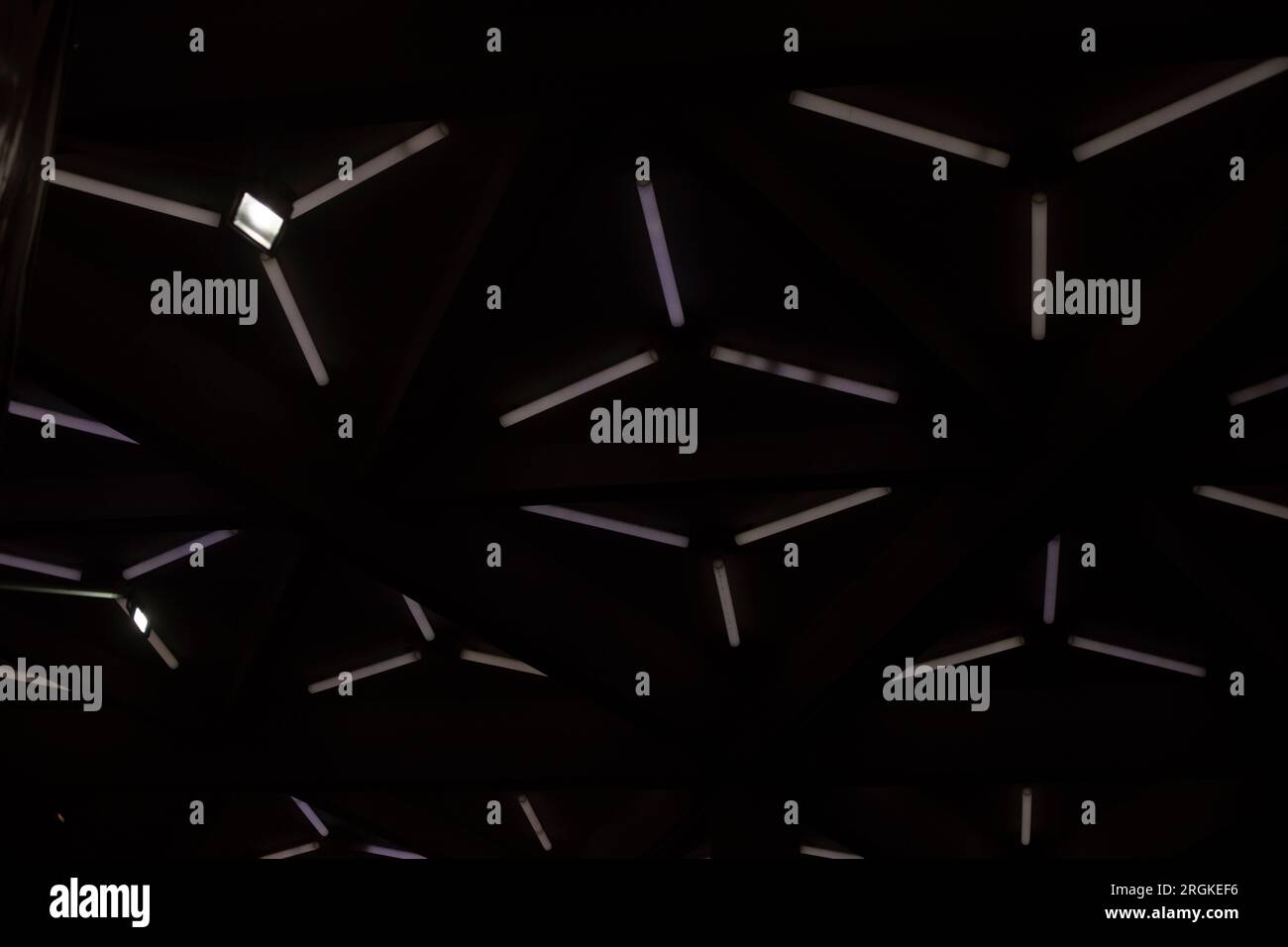 Triangular lamps on ceiling. Modern architecture. Light design. Texture ...