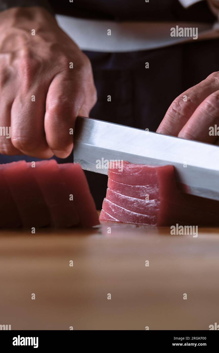 Male hands slicing fresh bluefin tuna loin Stock Photo - Alamy