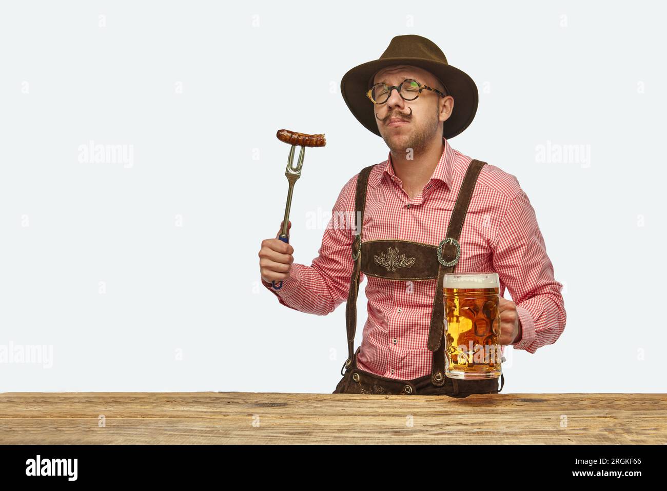 Taste Oktoberfest. Delightful man wearing traditional fest Bavarian or ...