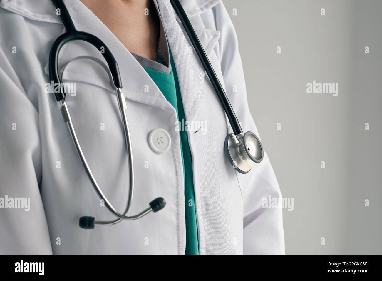 Crop anonymous female doctor in white medical uniform with professional ...